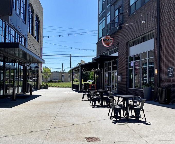 Outdoor tables bask in Georgia sunshine between modern buildings&mdash;the perfect spot for people-watching while tackling your burger creation.