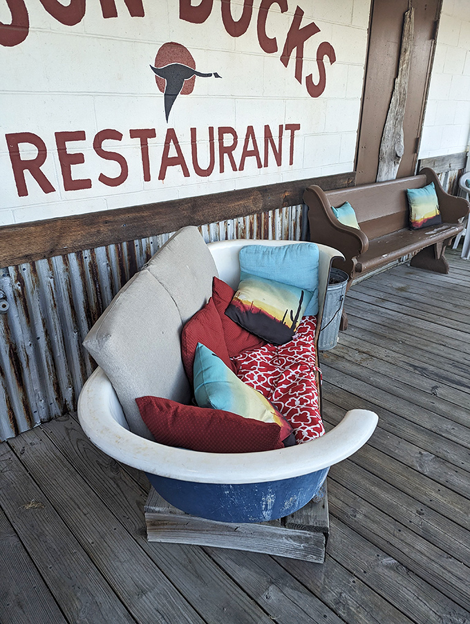 The outdoor waiting area that's more charming than any velvet rope line. That bathtub couch has heard more food dreams than a cooking show.