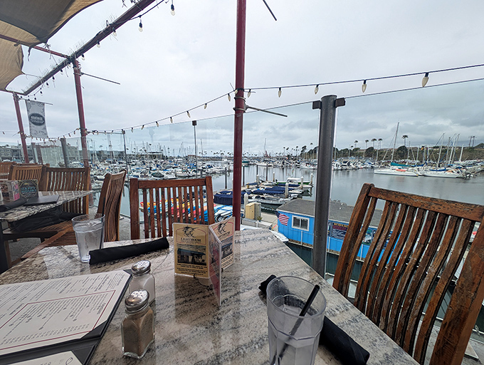 Harbor views that rival the food for attention—weathered wooden tables where every meal comes with a side of nautical ambiance.
