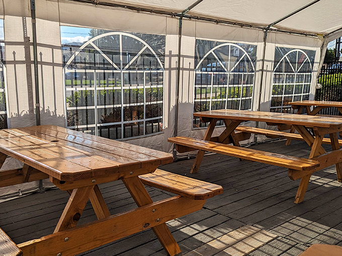 Rustic picnic tables under a protective tent create an al fresco dining option that feels like the world's most delicious camping trip.