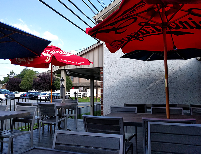 The outdoor seating area&mdash;where fresh air meets fresh food. Those red umbrellas aren't just for shade; they're beacons calling hungry travelers home. 