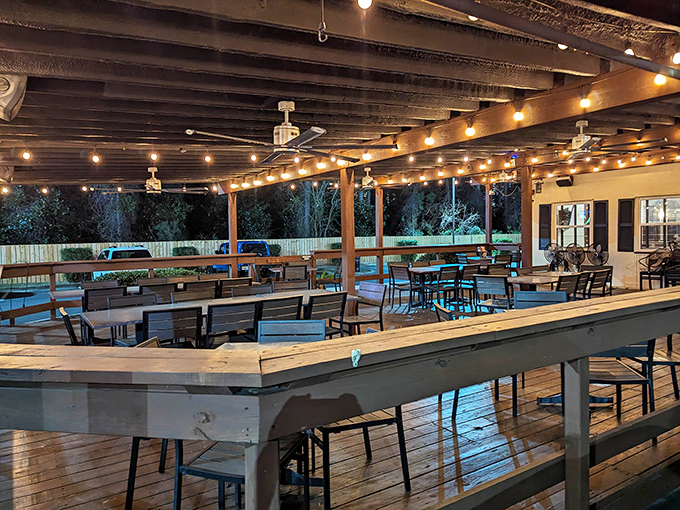 The outdoor seating area transforms into a magical space at night. String lights create the perfect ambiance for enjoying Florida evenings.