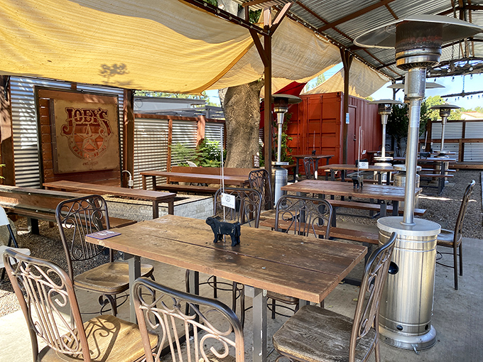 The outdoor seating area feels like the backyard barbecue of your dreams—if your dreams included professional-grade smokers and perfect Texas-style BBQ.