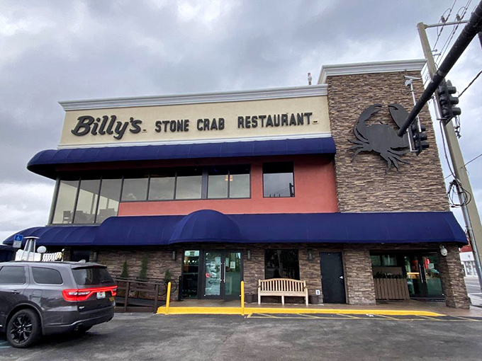 Billy's exterior with its signature blue awnings stands ready to welcome seafood pilgrims. Even cloudy days can't dampen the promise of stone crabs within.