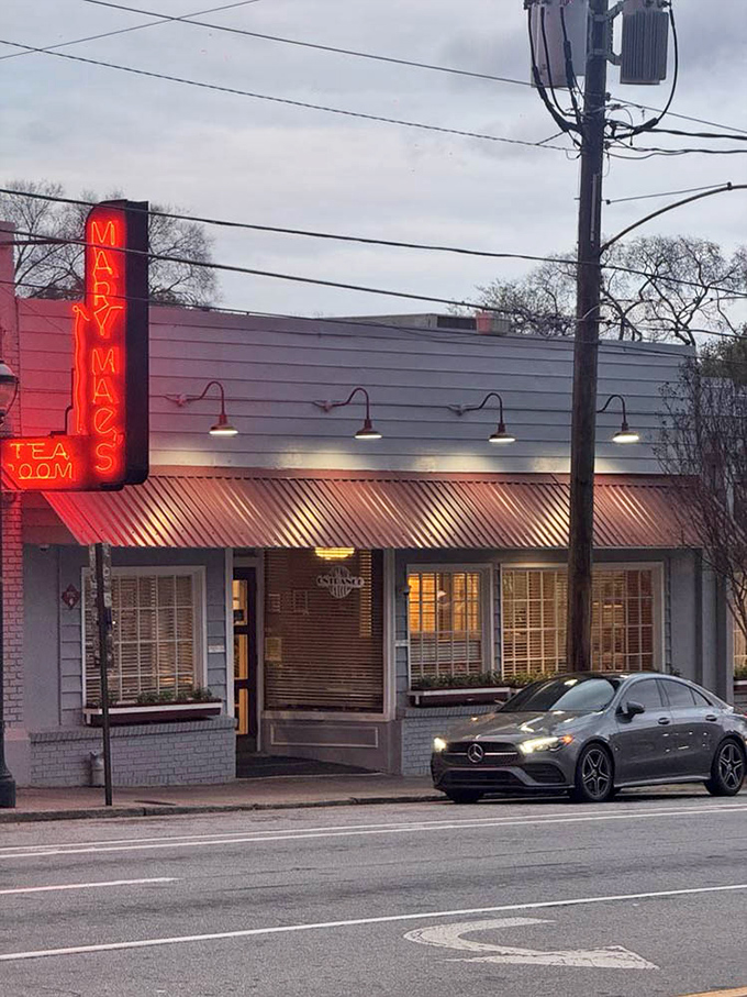 As dusk falls, that neon sign glows like a lighthouse for hungry travelers navigating the streets of Atlanta.