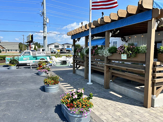The outdoor entrance, where colorful flowers in galvanized tubs welcome you to seafood paradise with coastal charm to spare.