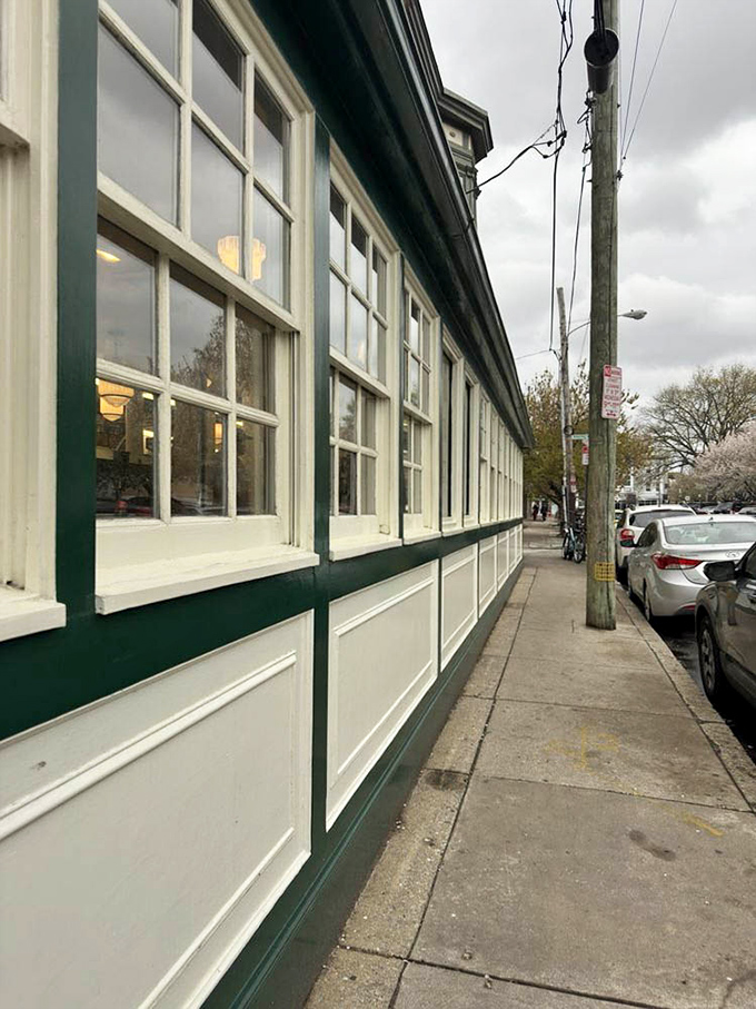 Green and white stripes frame windows that have watched the neighborhood evolve one sandwich at a time.