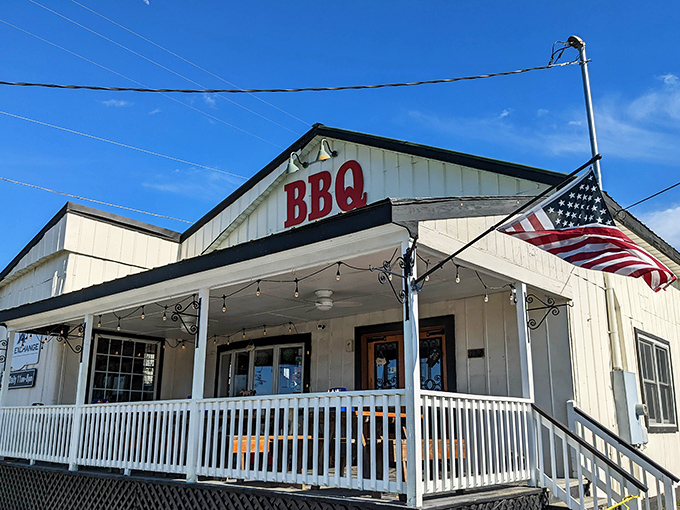 The American flag flutters proudly beside the BBQ sign&mdash;because few things are more patriotic than perfectly smoked meat on a summer day.