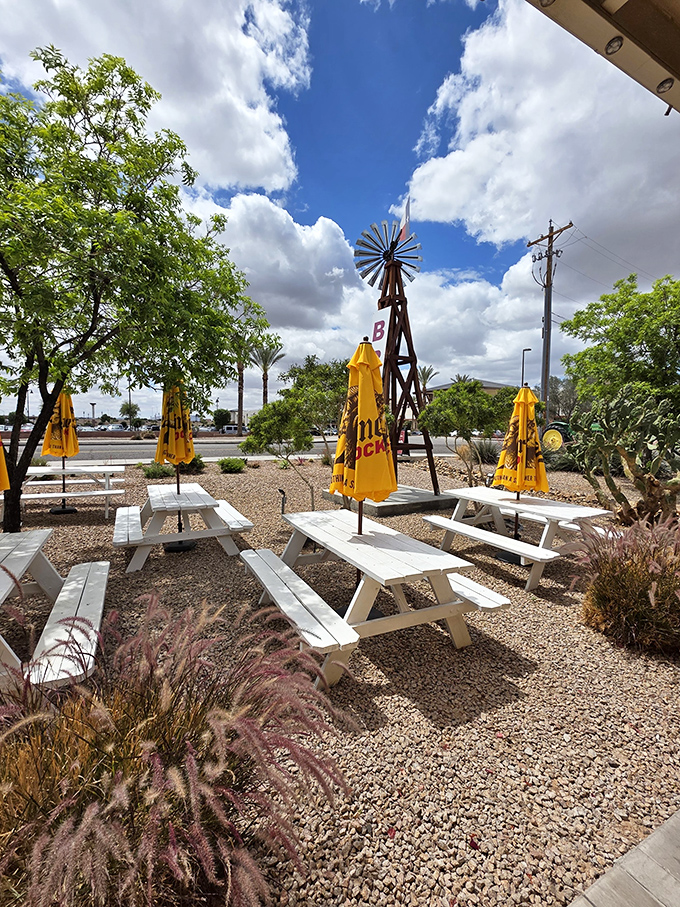 Desert landscaping meets BBQ paradise. White picnic tables under yellow umbrellas &ndash; Arizona's answer to the traditional Texas BBQ yard.