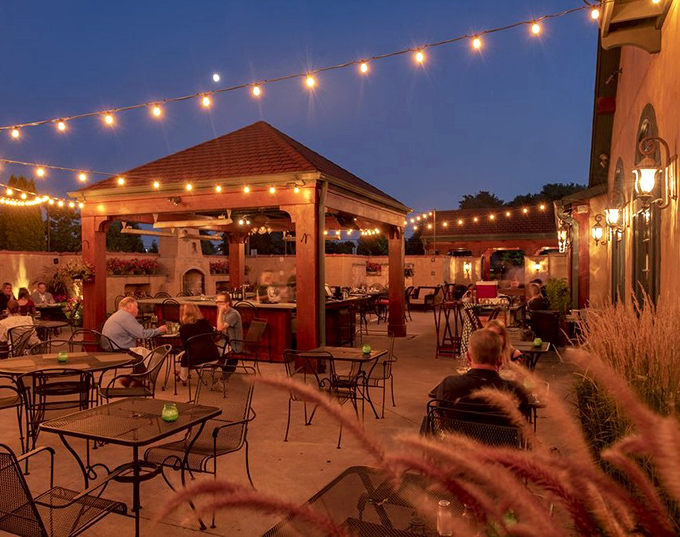 The outdoor patio under string lights creates the kind of magical summer evening that Wisconsinites dream about all winter long.