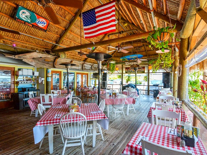 Red-checkered tablecloths under a thatched roof with water views – this is the Florida dining experience tourists dream about and locals never take for granted.