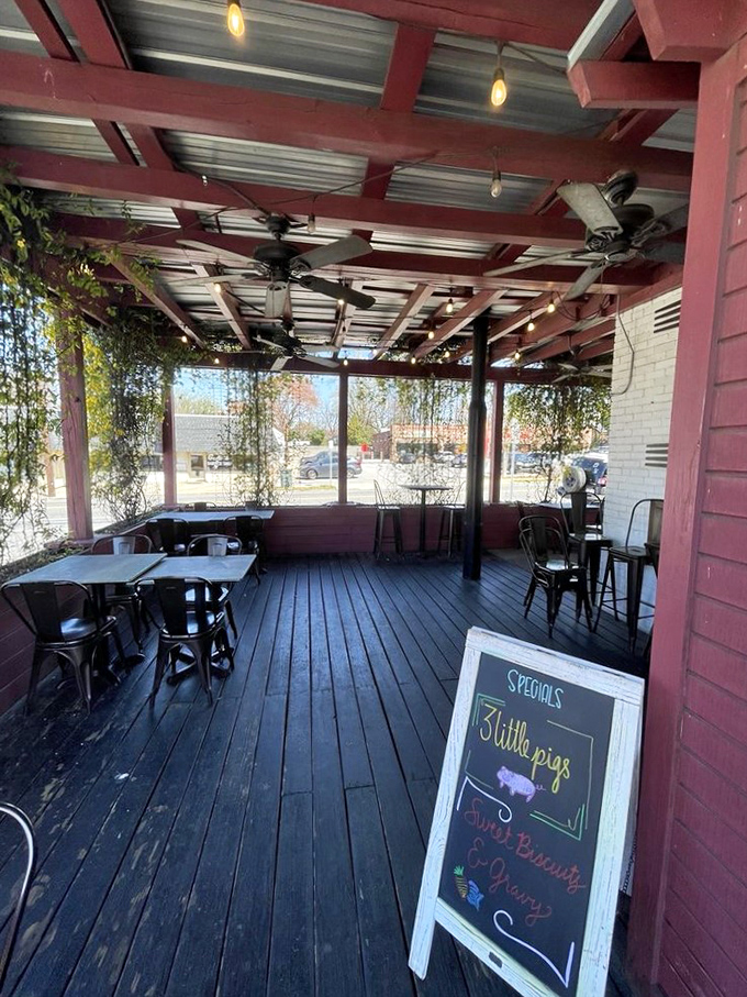 Outdoor dining under a canopy of vines makes every breakfast feel like a secret garden party. The specials board hints at porky delights.