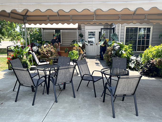 Outdoor seating surrounded by lush plants creates the perfect backdrop for the important business of savoring every bite.