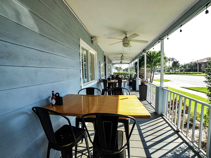 Porch seating where the Florida breeze enhances your coffee experience&mdash;nature's version of atmosphere enhancement.