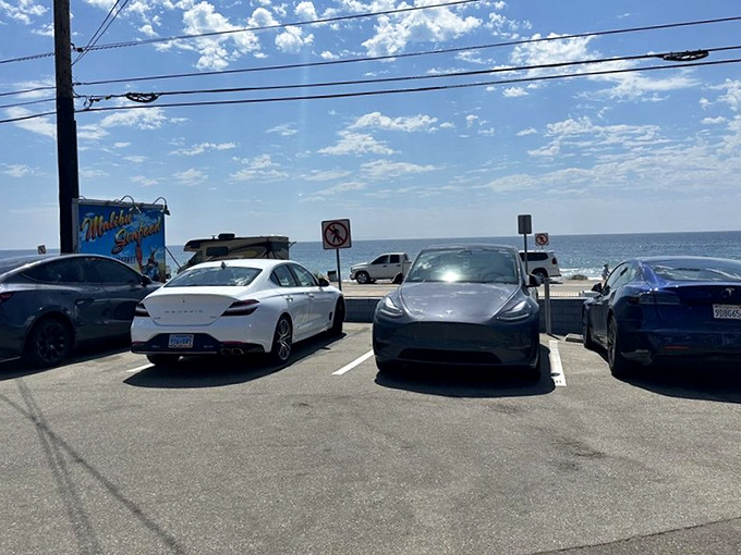 The parking lot&mdash;where Teslas and pickup trucks share the same mission: securing the best seafood on PCH. Democracy in action.