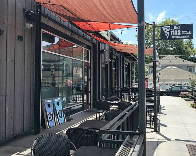 The sidewalk seating area &ndash; where pizza voyages begin and diet promises end. Those red awnings practically whisper, "Come sit a while."