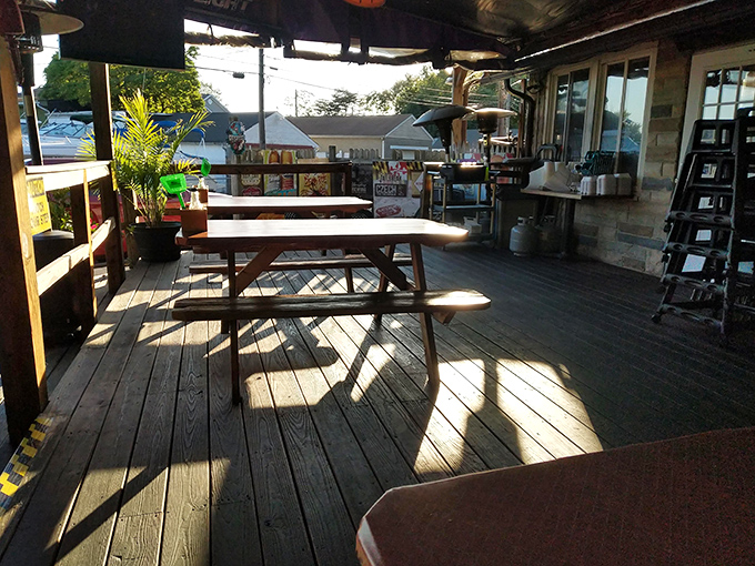 Sunlight dances across wooden picnic tables on the deck, creating the perfect casual setting for serious seafood consumption.