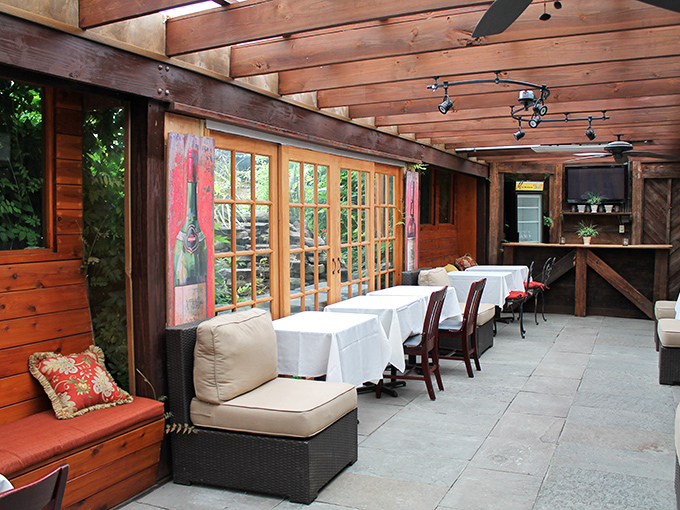 The covered patio brings the outdoors in with wooden beams and natural light, creating a rustic-elegant space for fair-weather dining.