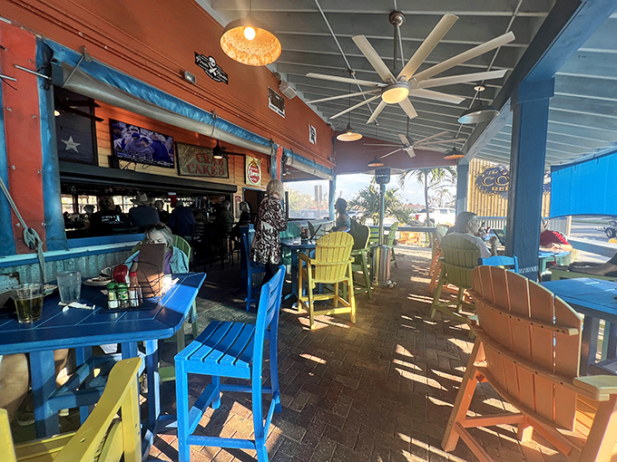 The covered patio offers the perfect middle ground between indoors and out. Those colorful chairs are like a rainbow that followed through on its promise of treasure.