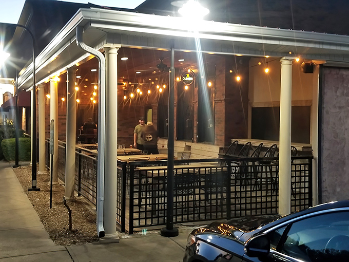 The outdoor patio glows with string lights after sunset, creating an al fresco dining space that feels like a neighborhood backyard party.