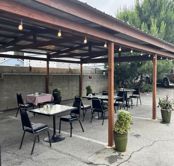 Outdoor dining under string lights – where simple tables transform into California oases, perfect for people-watching with your patty melt.