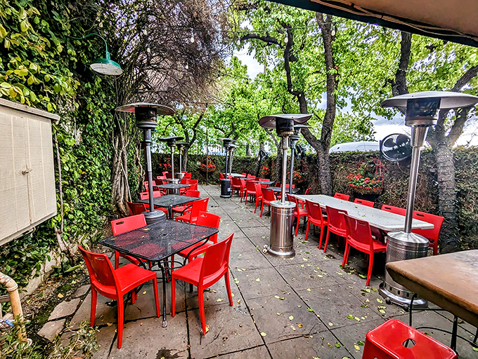 The patio's red chairs pop like exclamation points in a love letter to al fresco dining.