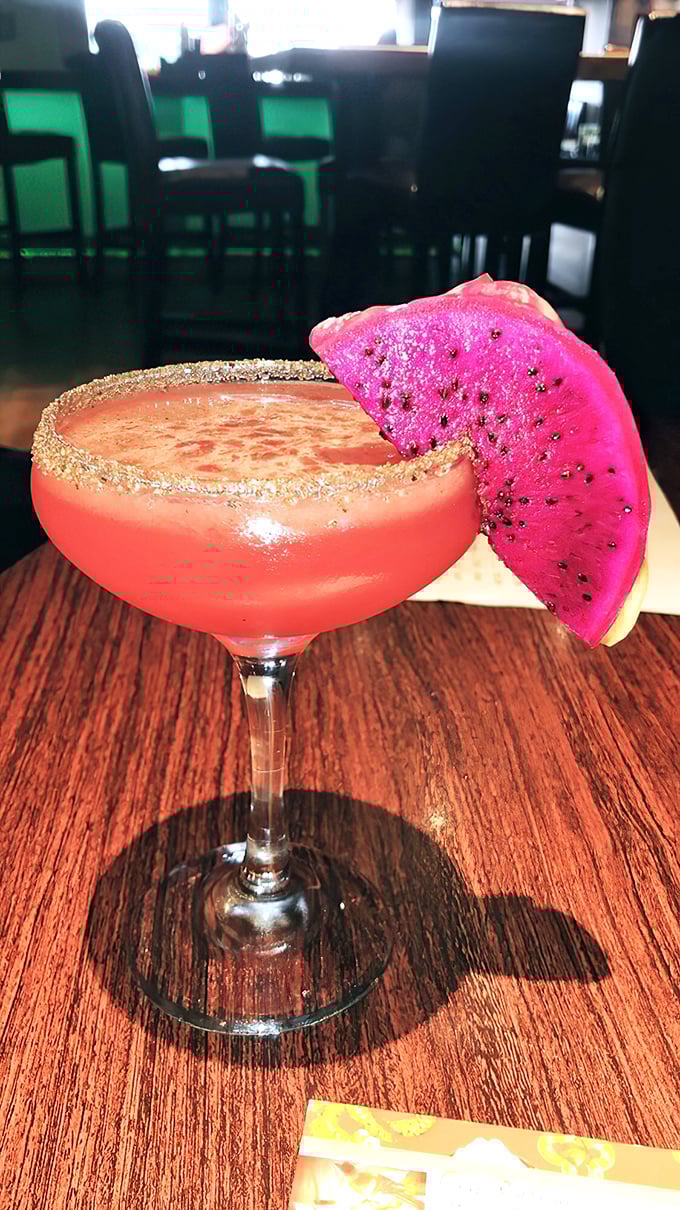 This isn't just a cocktail; it's a tropical vacation in glassware. The dragon fruit garnish is essentially wearing a hot pink party hat.