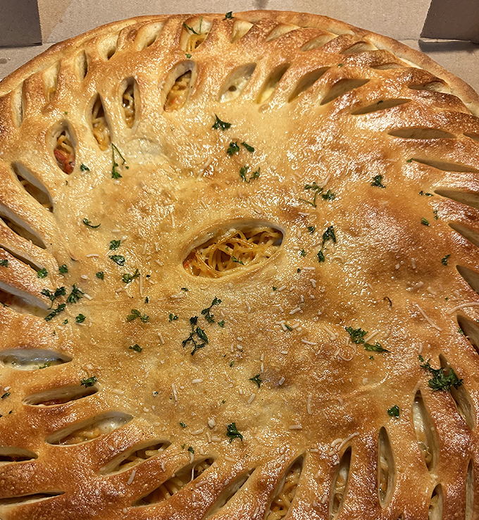 A golden-brown pastry masterpiece with decorative vents that aren't just pretty&mdash;they're little windows into a world of delicious filling.