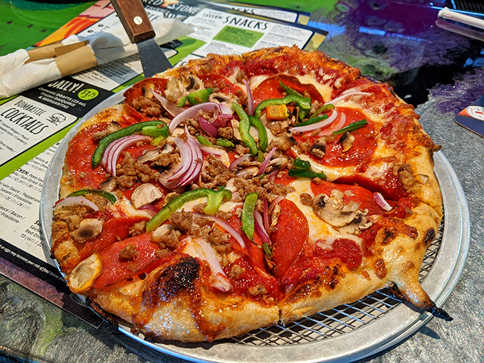 Pizza perfection with a generous topping-to-crust ratio. The colorful medley of vegetables and meats creates a symphony of flavors in every slice.