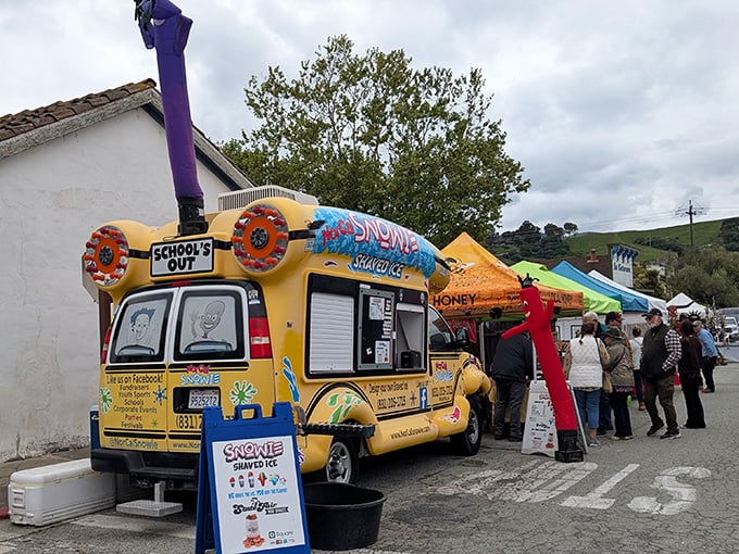 Food truck culture meets small-town festival vibes. Even the inflatable tube man seems genuinely excited about the offerings.
