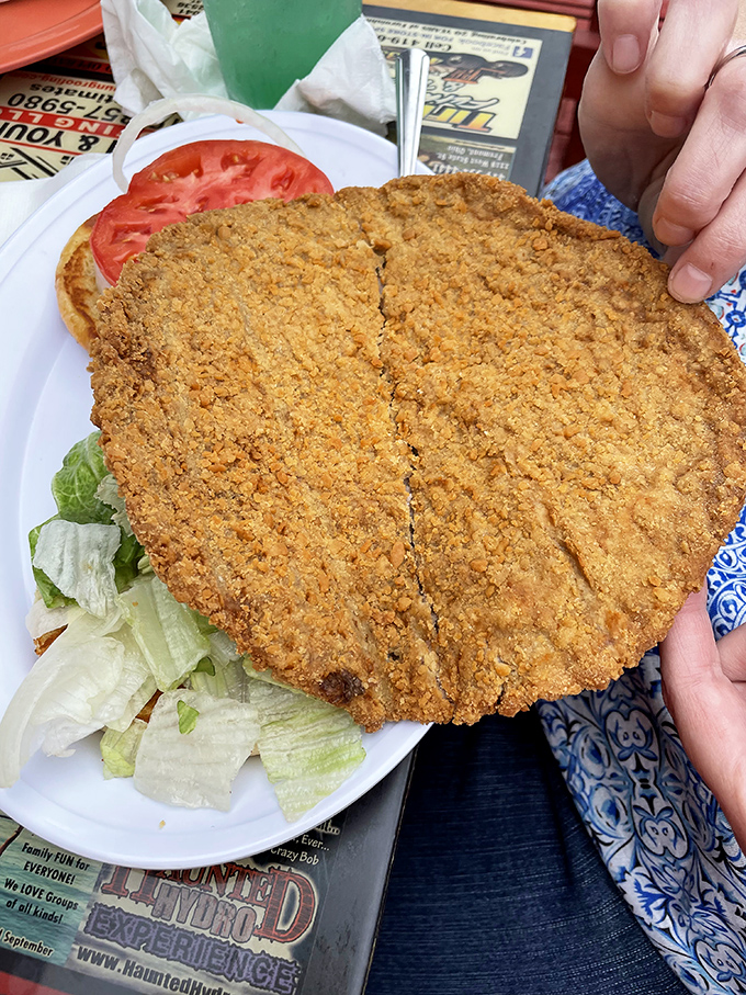 The breaded pork tenderloin stretches well beyond its bun boundaries &ndash; a Midwest tradition that asks the important question: "Why should bread get all the attention?"