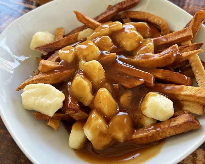 Poutine gets a breakfast makeover with banana slices standing in as sweet counterpoints. Crispy fries swimming in gravy that would make a Canadian nod approvingly.