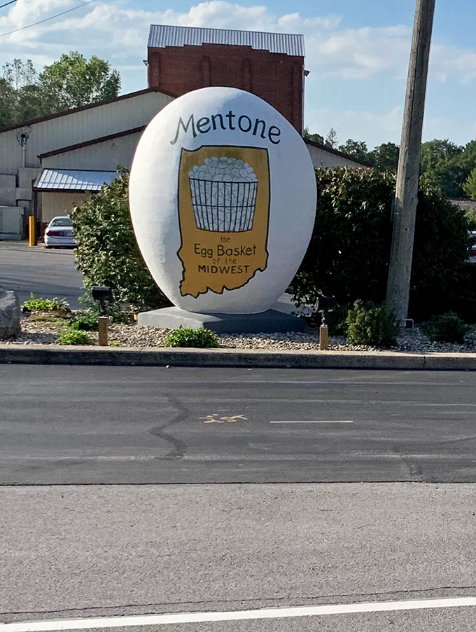 From across the street, the egg commands attention against the backdrop of classic small-town America architecture.