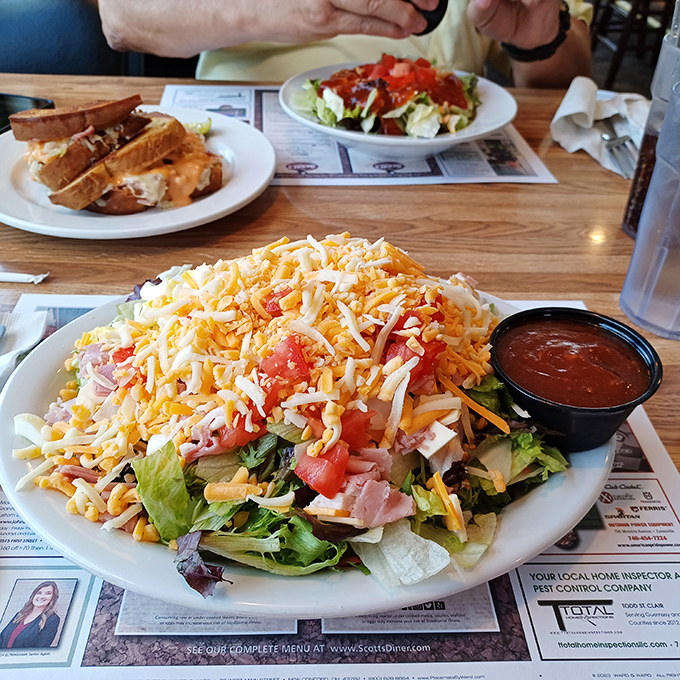 A salad so generous it has its own zip code, proving that even the "healthy option" at Scott's refuses to leave you hungry.