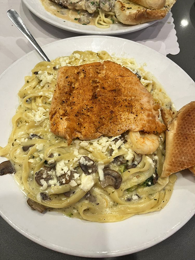 Pasta that doesn't just sit on the plate&mdash;it performs! Creamy fettuccine studded with mushrooms and crowned with perfectly seasoned salmon.
