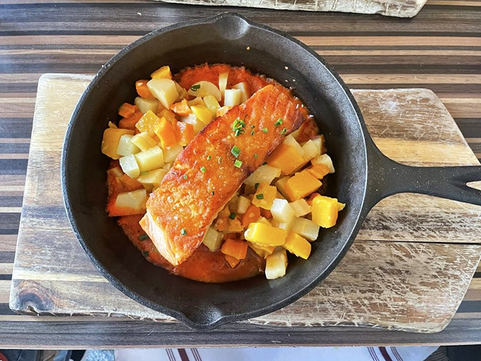 Salmon nestled in root vegetables like it's posing for a "how to eat healthy without feeling deprived" magazine cover.