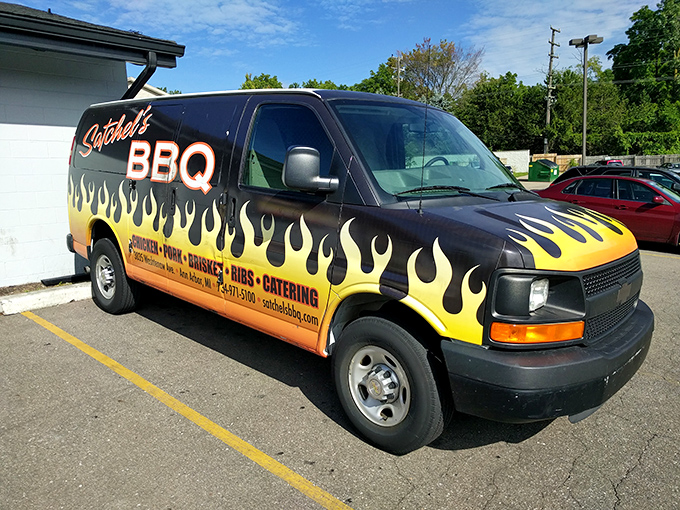 The Batmobile of barbecue&mdash;Satchel's catering van announces its arrival with flames that promise smoky delights within.
