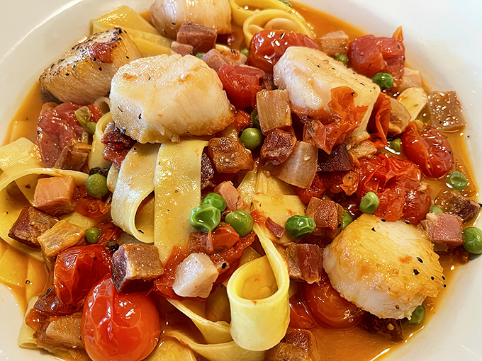 Plump scallops and pancetta playing hide-and-seek among pappardelle ribbons&mdash;a seafood symphony that makes you want to applaud between bites.