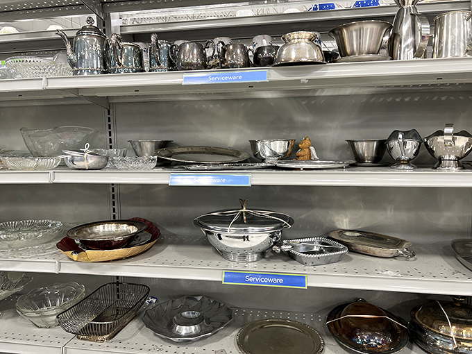 Silver serving pieces gleam under fluorescent lights, waiting to elevate someone's dinner party. Grandmillennial style without the inheritance required.