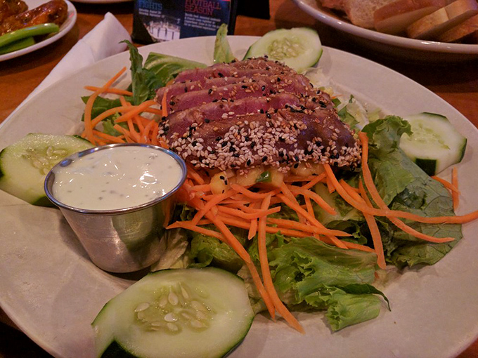Sesame-crusted tuna perched atop greens like it's posing for a healthy lifestyle magazine. A salad that satisfies without triggering menu envy.