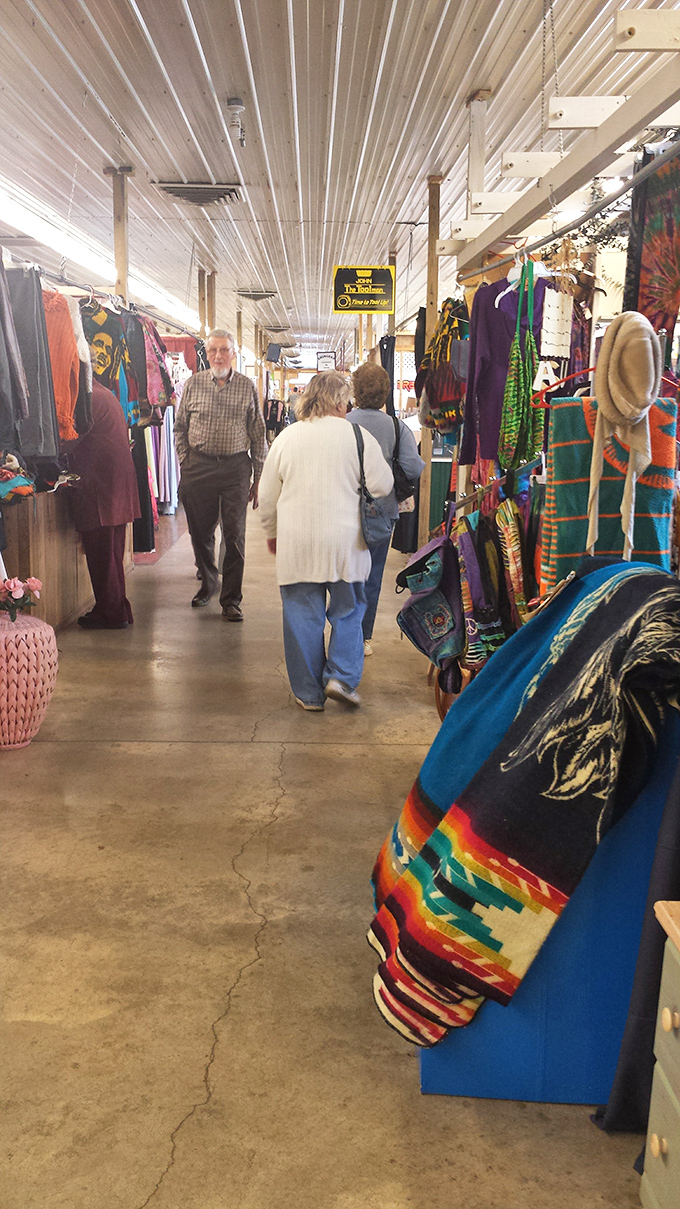 The indoor marketplace hums with the energy of discovery as shoppers navigate aisles filled with colorful textiles and potential finds.
