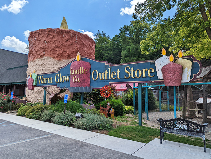 Summer sunshine showcases the candle in all its waxy glory, standing sentinel over a garden that would make any green thumb jealous.