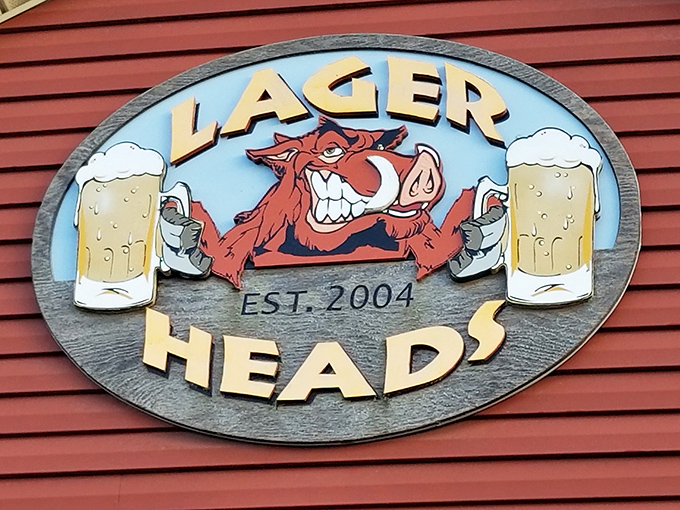 The cheerful boar mascot sign welcomes visitors to a place where serious barbecue meets genuine small-town hospitality.