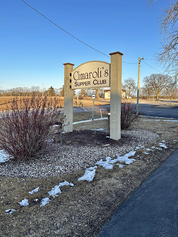 The sign stands as a beacon for hungry travelers. Like a lighthouse guiding ships to safe harbor, it directs appetites to their happy place.