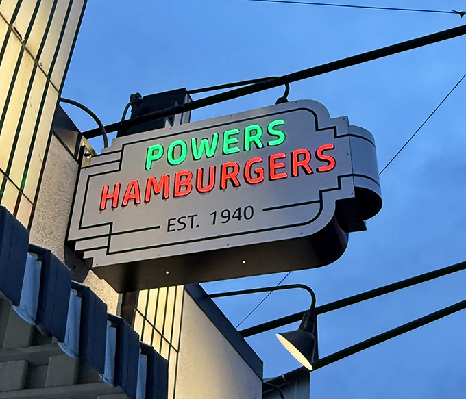 The vintage neon sign doesn't just advertise a restaurant; it announces an institution where Fort Wayne's burger traditions have been preserved since 1940.