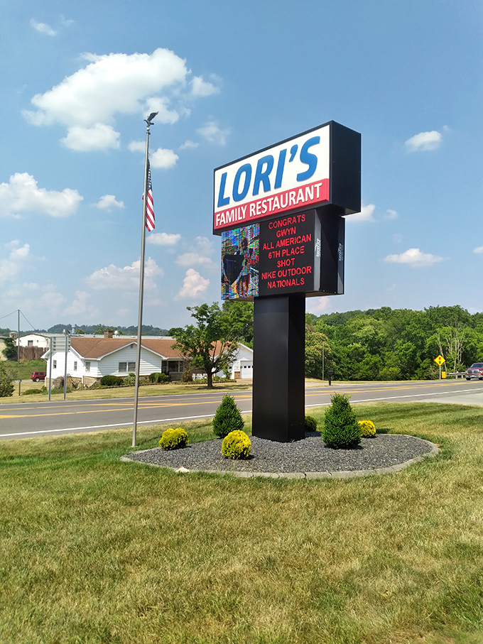 The roadside sign doesn't just announce a restaurant—it celebrates local achievements, proving Lori's is woven into community fabric.