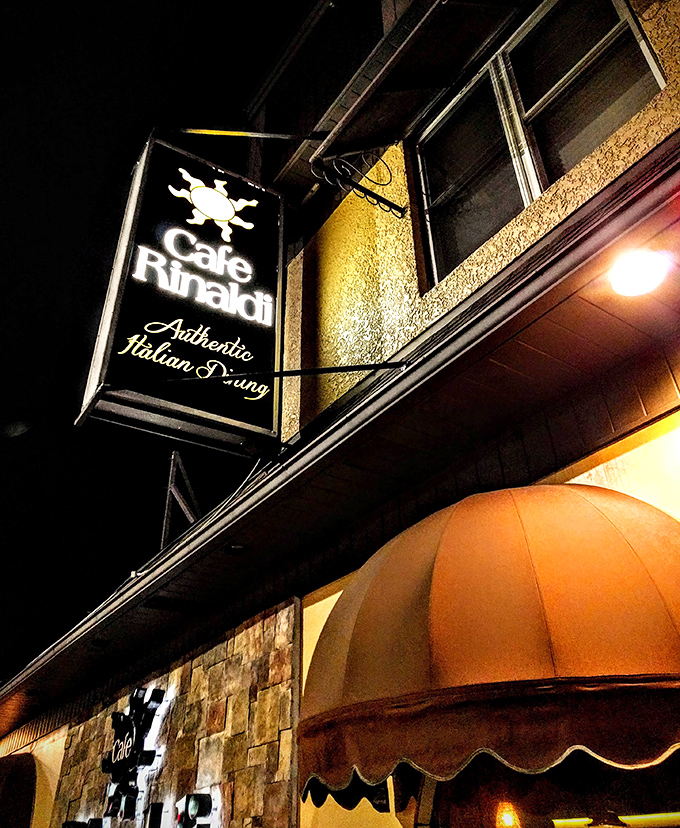 The illuminated sign doesn't just announce a restaurant&mdash;it signals the presence of "Authentic Italian Dining" that generations of locals have treasured.