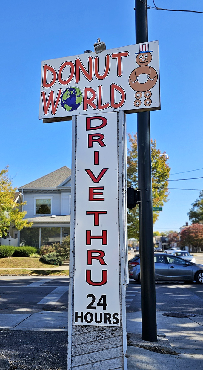 The iconic sign announces "DRIVE THRU 24 HOURS" like a beacon of hope for night owls and early risers alike. Donut emergencies wait for no one.