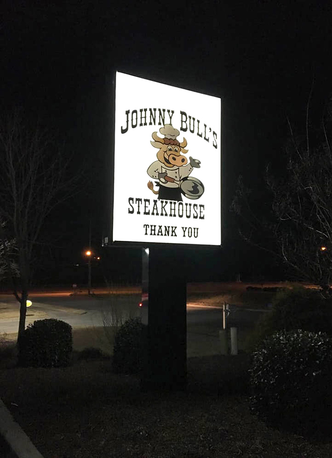 The illuminated sign serves as a beacon for hungry travelers, promising satisfaction with a side of small-town charm.