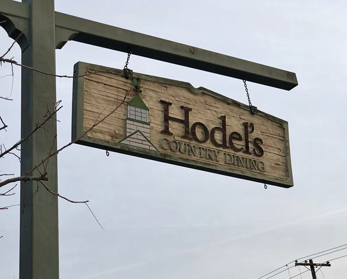 The weathered wooden sign swings gently in the Bakersfield breeze, a rustic beacon for hungry travelers seeking home-style cooking.